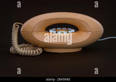 Peach coloured 1970's Modern telephone handset Stock Photo - Alamy