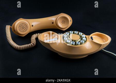 Peach coloured 1970's Modern telephone handset Stock Photo - Alamy
