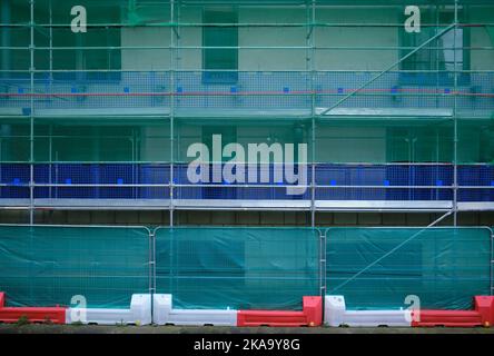 mesh-covered scaffolding during building restoration work Stock Photo ...