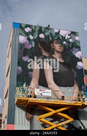 Artist Zane Prater paints a mural during Asalto International Urban Art ...
