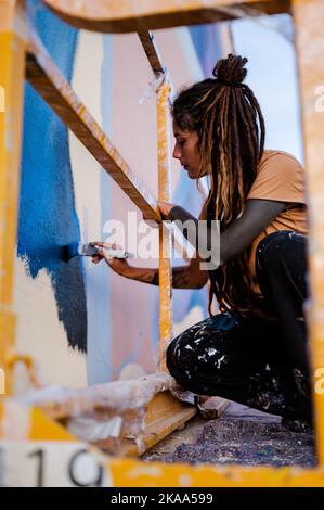 Process of creating graffiti, street artist with aerosol spray paint ...