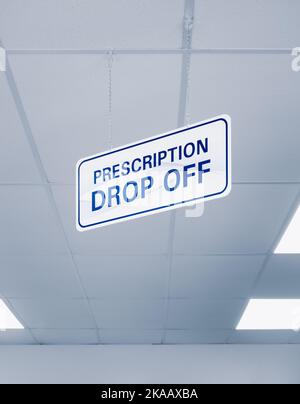 Plain white and blue prescription drop-off sign hanging from an ...