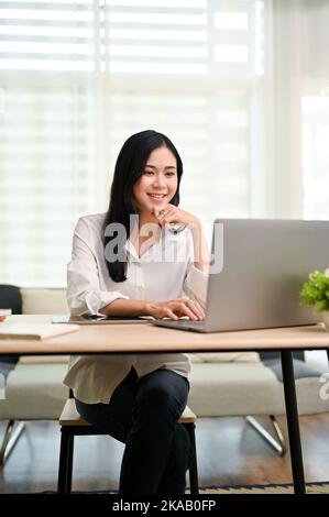 Charming asian young businesswoman searching an inspiration on the ...