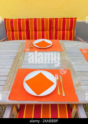 tableclothes at a teak table in the garden Stock Photo - Alamy