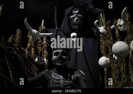 A reveler dressed up depicting a traditional folklore creature poses ...