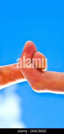 two fingers are connected with blue sky Stock Photo - Alamy