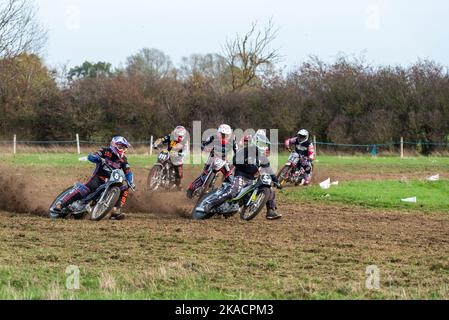 GT140 solo class riders racing in grasstrack motorcycle race. Donut ...