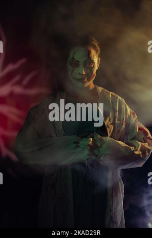 Young woman portrays bloodthirsty zombie with horror wounds on her face ...