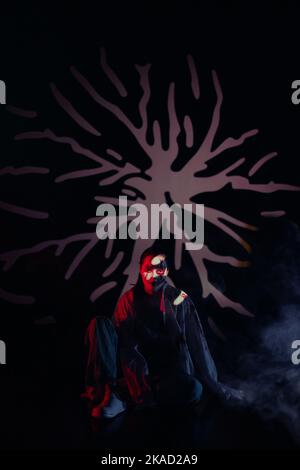 Young woman portrays bloodthirsty zombie with horror wounds on her face ...