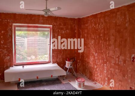 Renovation of a flat with red primer paint on the walls Stock Photo - Alamy