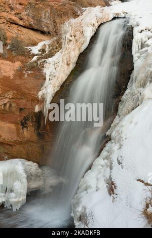 Partially frozen Faux Falls in winter in the desert near Moab, Utah ...