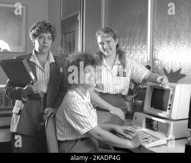 1980s, historical, office workers sitting at desks using computer ...