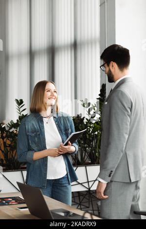 Smiling businessman holding folder during an interview Stock Photo - Alamy