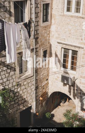 Vertical shot of laundry hanging from balconies in the streets of ...