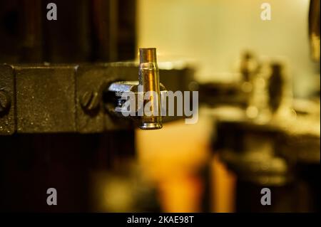Clamp with brass bullet casing at ammo production plant Stock Photo - Alamy