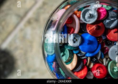 assortment random colored loose buttons in a glass jar Stock Photo - Alamy