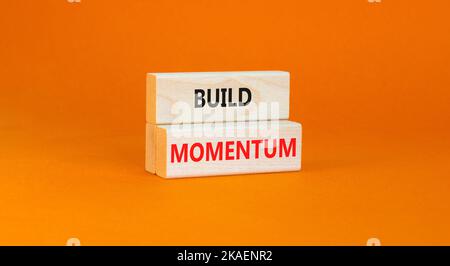 Build momentum symbol. Concept words Build momentum on wooden blocks ...