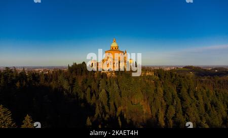 An aerial view of San luca chuch surrounded by dense trees in Italy ...