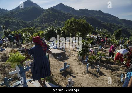 An indigenous woman traditionally called "Panchita" places flowers on a ...