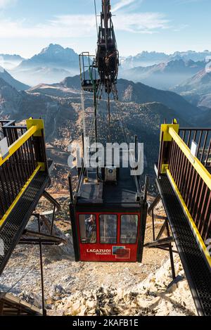 A gondola of the Lagazuoi cable car approaches the top station in front ...
