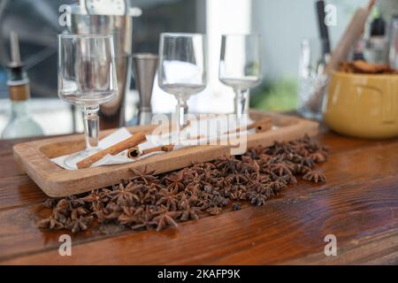 A closeup shot of a wooden cup holder with star anise and cloves in ...