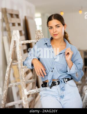 Pretty cottage owner posing in room being renovated Stock Photo - Alamy