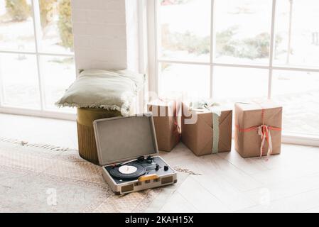Vintage vinyl record player and gift boxes by the window in the house ...
