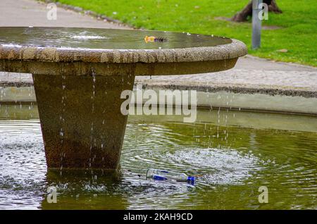 Disfigured spring fountain in the city park of Freiburg im Breisgau ...