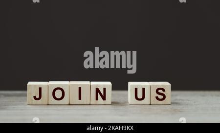 Join us word on wooden blocks on wood table. Copy space. White ...