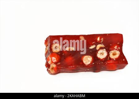 Red piece of Arabian sweet candy domeya stuffed with hazelnuts ...
