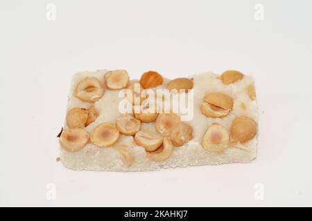 Soft coconut candy covered with hazelnuts, Egyptian cultural desserts ...