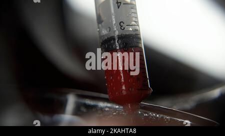 Syringe from which blood is drawn, taking medical blood sample ...