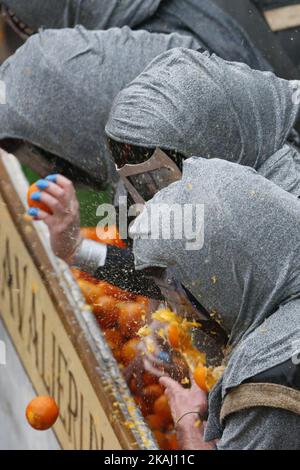 orange throwers on horse-drawn carts hit by the oranges throwed by ...
