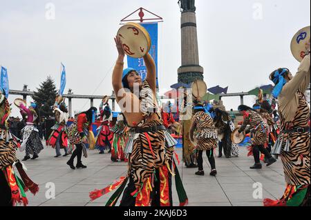 People perform Shaman Dance to pray at the opening of the Kaijiang ...