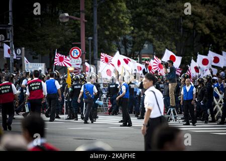 Japanese riot police guards the group of Anti-PM Shinzo Abe's members ...
