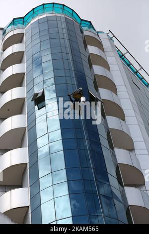 A Palestinian window cleaner works at the al-Zafer building in Gaza ...