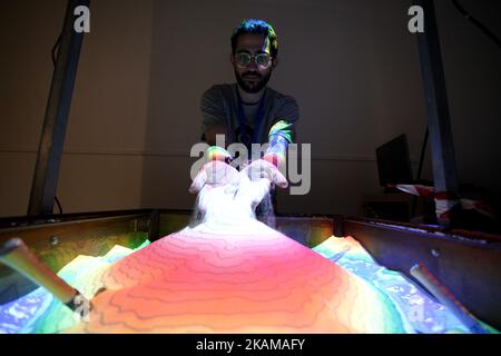 Augmented reality sandbox allows users to create topography models by ...