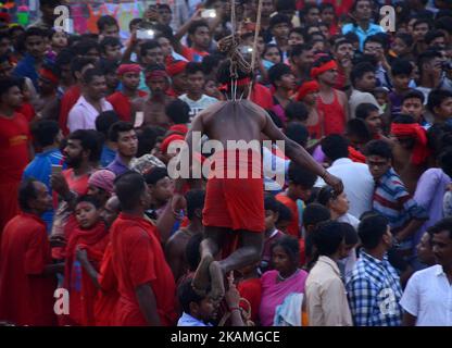 Indian Hindu devotee hanged from rope with iron hook during the Gajan ...