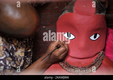 GHAMBIR NEKHU, 46 yrs old, priest painting on Statue of Idol Rato ...
