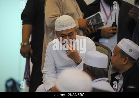 Malaysian Prime Minister Abdullah Ahmad Badawi pours water on his first ...