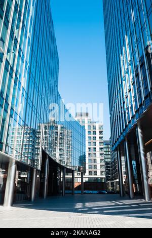 Walkway between modern glass buildings with metal columns Stock Photo ...