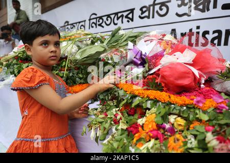 Bangladeshi people lay flowers to pay tribute to the victims of the ...