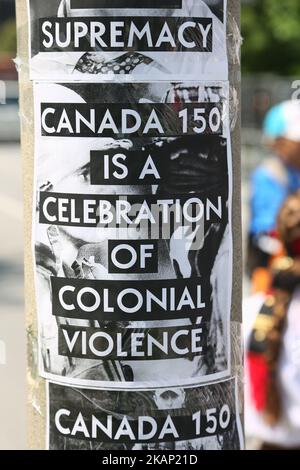 A First Nation Canadian protests with a native flag against the ...