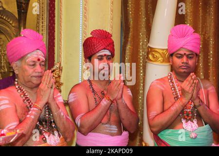 Tamil Hindu priests perform special prays as they bathe a large stone ...