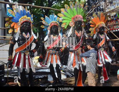 An Indian artisan prepares the statue of Red Indians in a Puja pandal ...