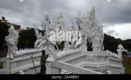 An Indian artisan prepares the temple of Thailand in a Puja pandal of ...