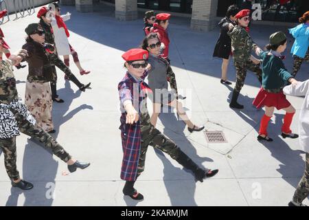 Chinese dancers dressed in military fatigues practice before a ...