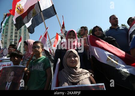 Residents hold pictures of Egyptian President Abdel-Fattah el-Sissi ...