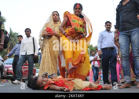 Devotees cross over children lying on the road during Chhata Puja ...