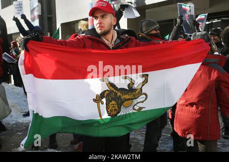 A protester holds and national flag upside down, Monday, June 9, 2025 ...